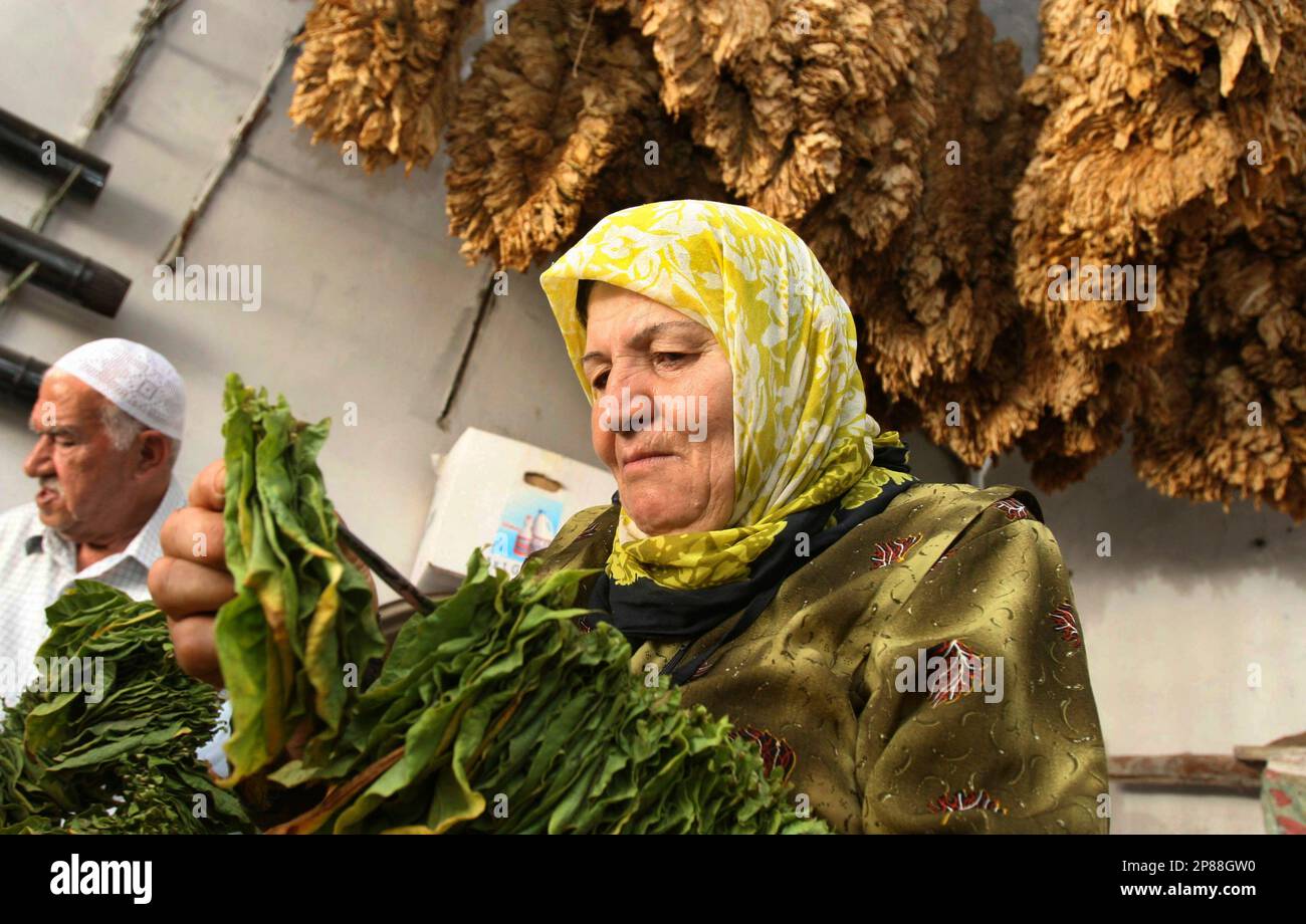 Lebanese Fatima Yassin, right, and her husband Kamal Habla stack ...