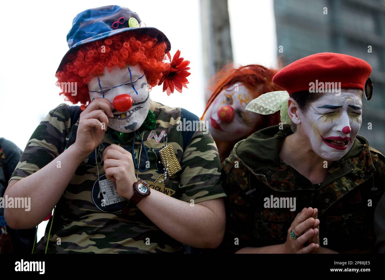 Demonstrators dressed as clowns protest against the oath taking of ...