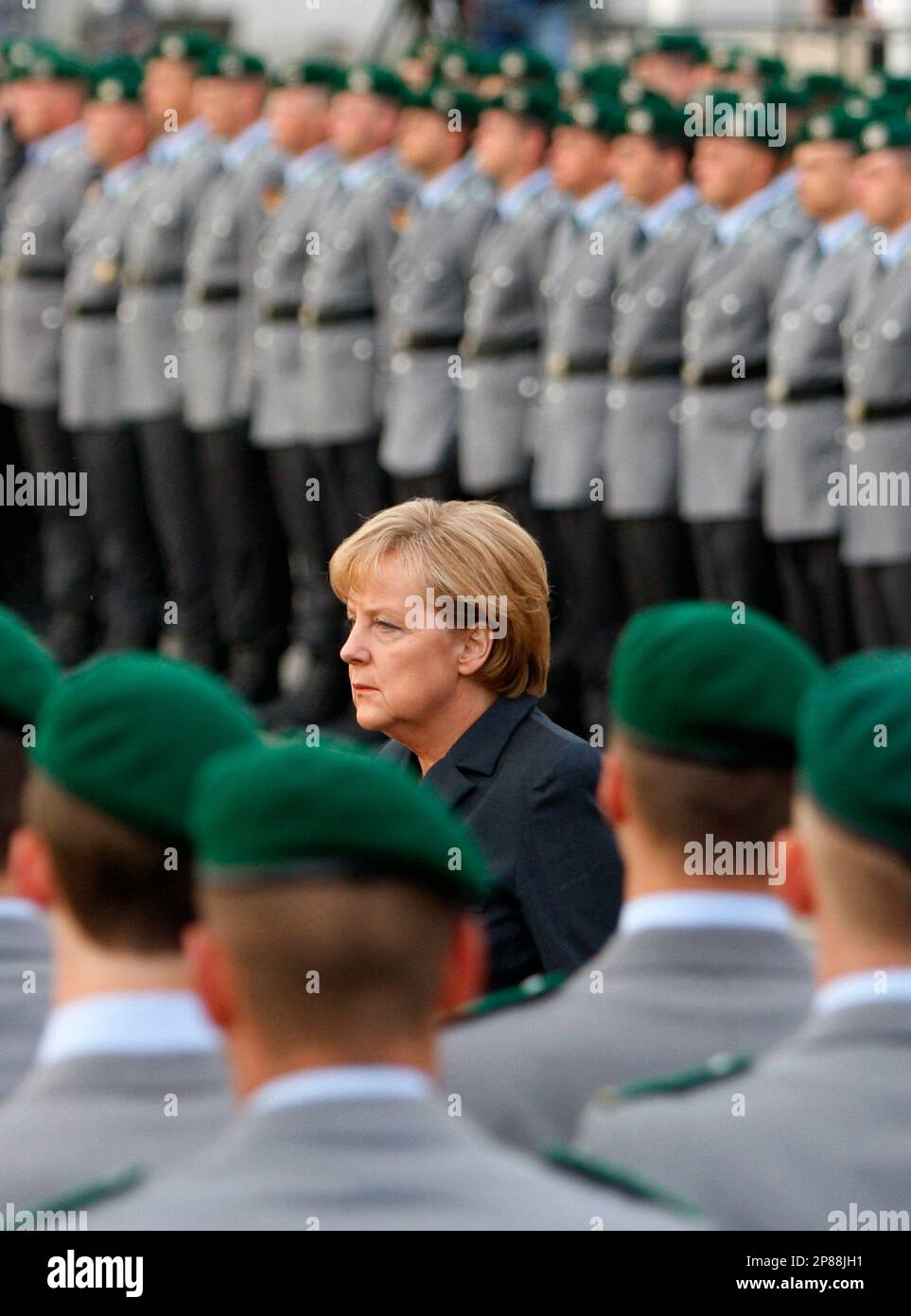 German Chancellor Angela Merkel, seen with soldiers, in front of the ...
