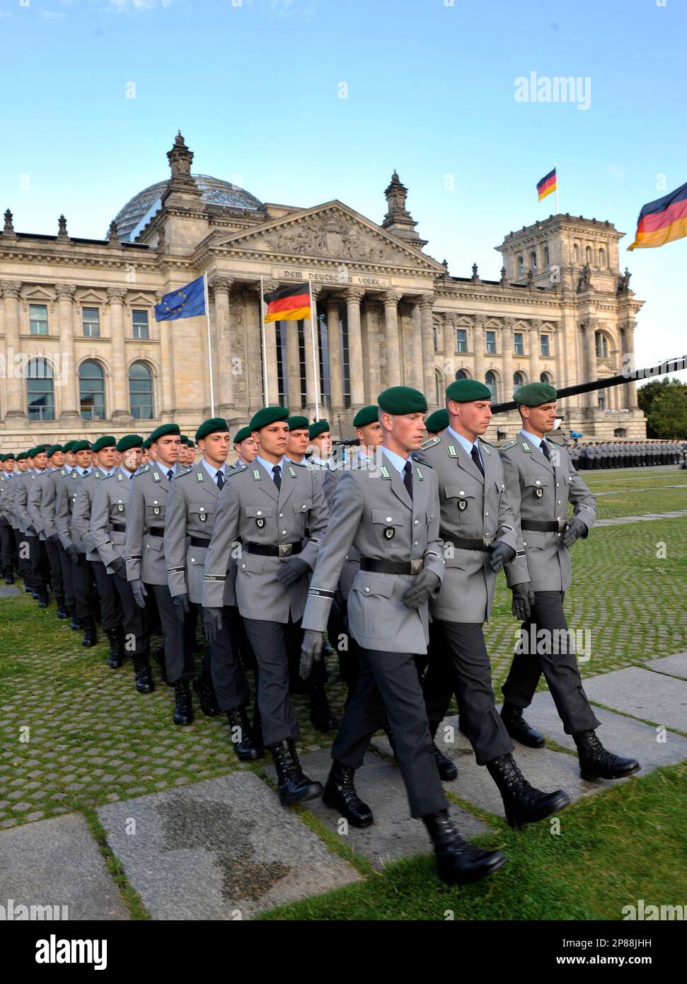 Soldiers of German Bundeswehr march in front of the Reichstag, which ...