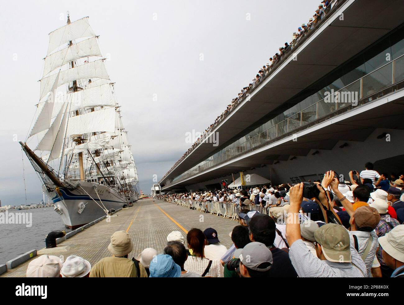 Tens of thousands of spectators look at the Japanese sailing ship ...
