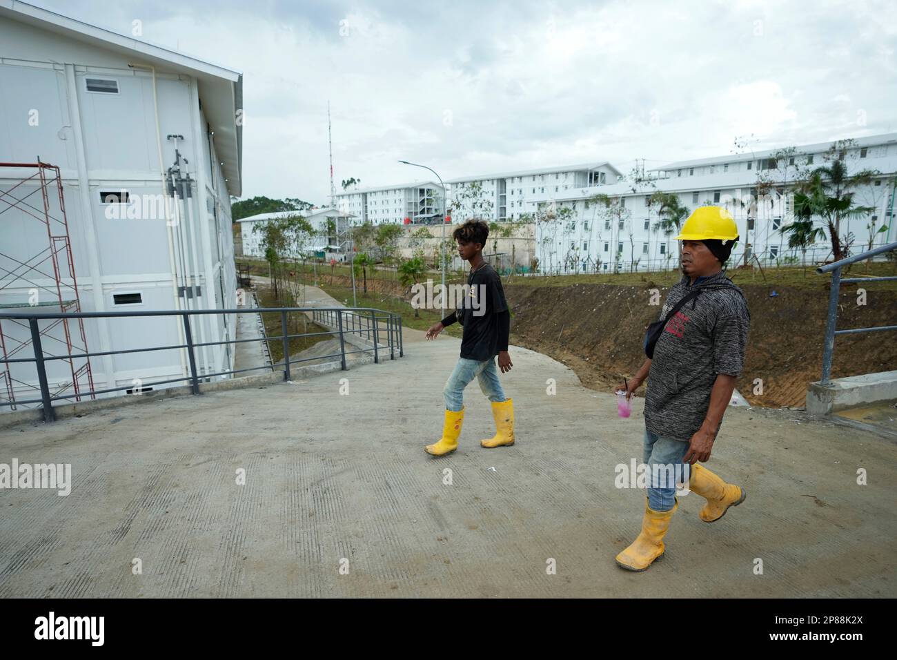 Workers walk at the construction site of the new capital city in ...