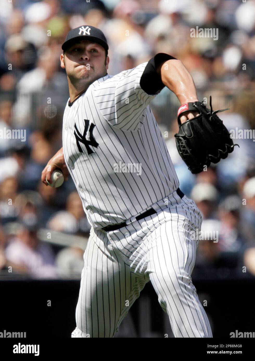 New York Yankees' pitcher Joba Chamberlain throws to first base for an ...