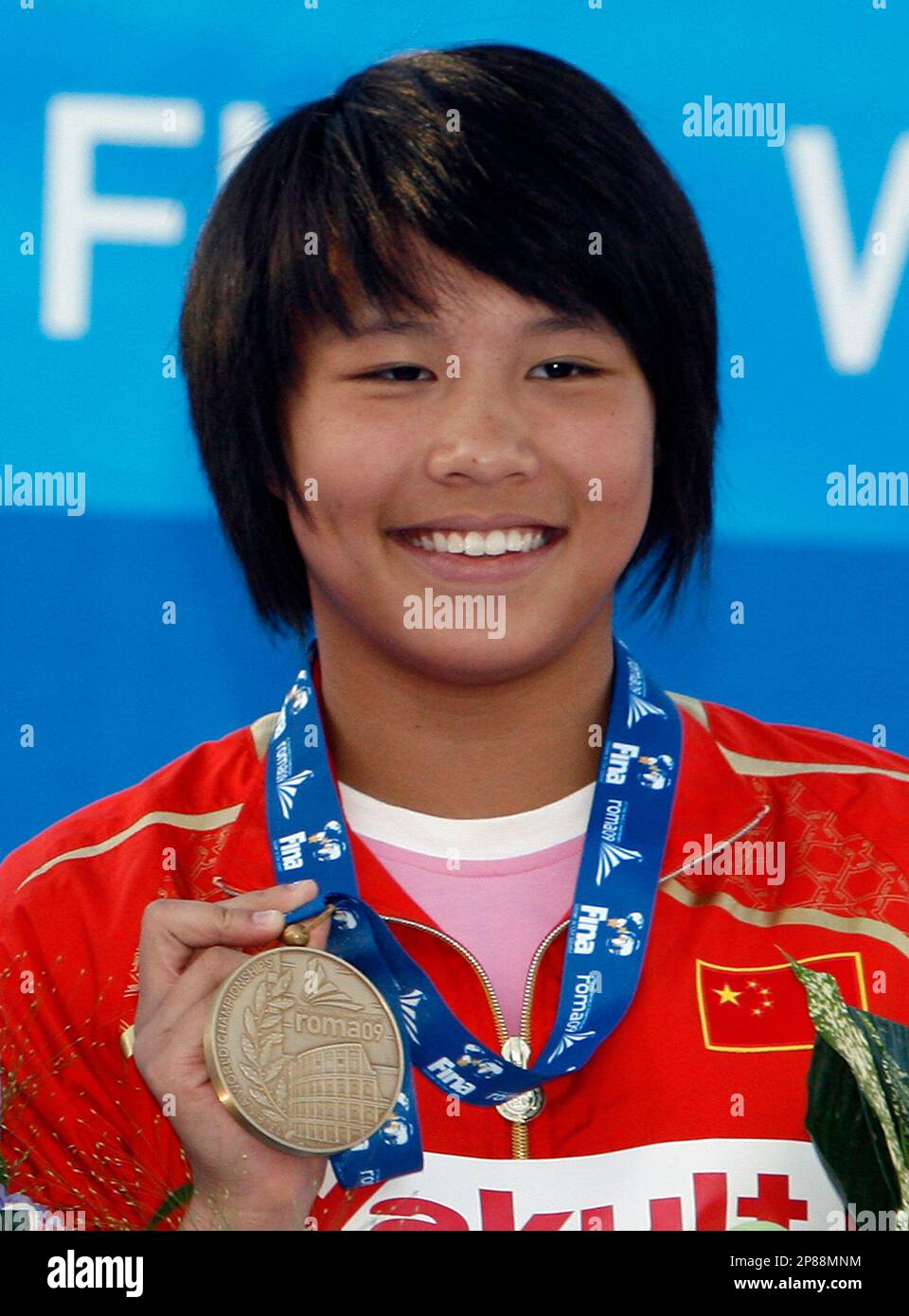 China's Wang Han shows the bronze medal of the women's 1-meter ...