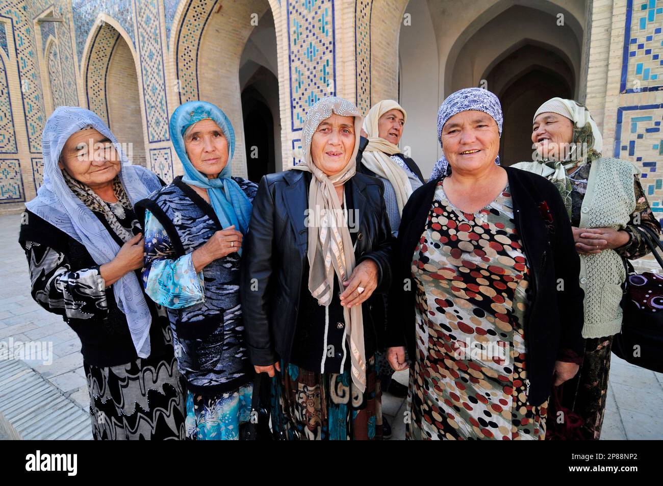 Uzbek women visiting the Kalan Mosque in the old city of Bukhara ...