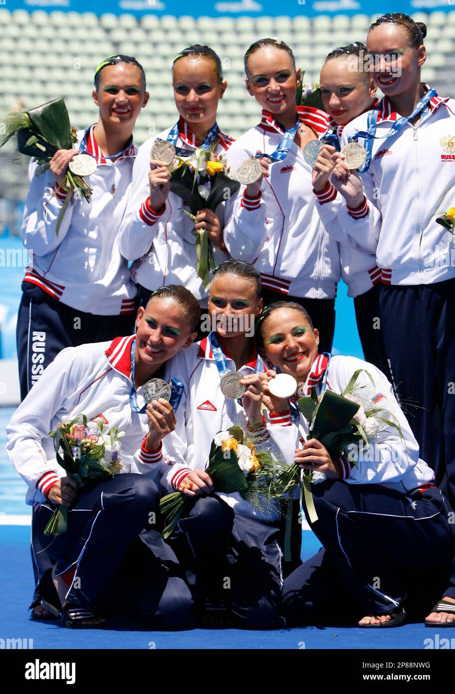 The Russian team show their gold medals after winning the team ...