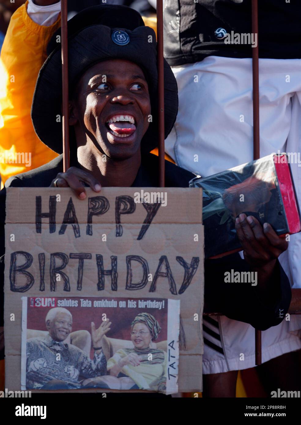 A South African soccer fan holds a poster with a photo of Nelson ...