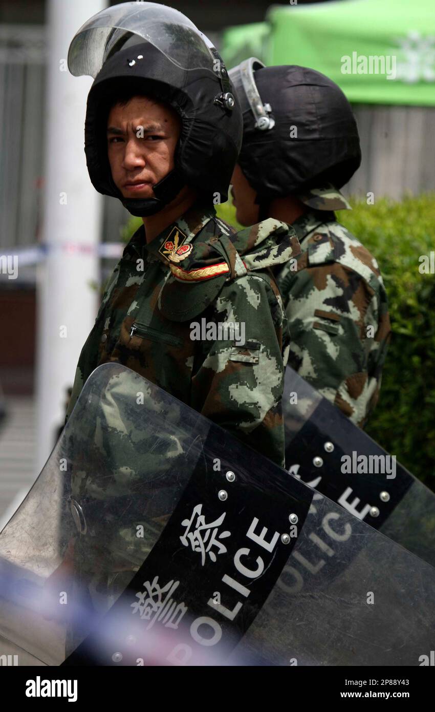 Paramilitary police stands guard in the streets of Urumqi, China ...