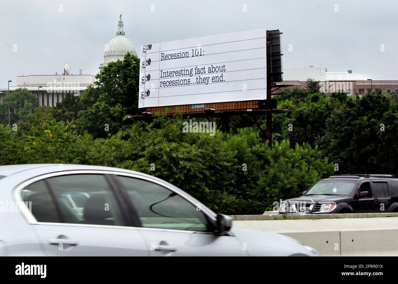 Cars drive by a billboard appearing along Interstate 95, with the ...