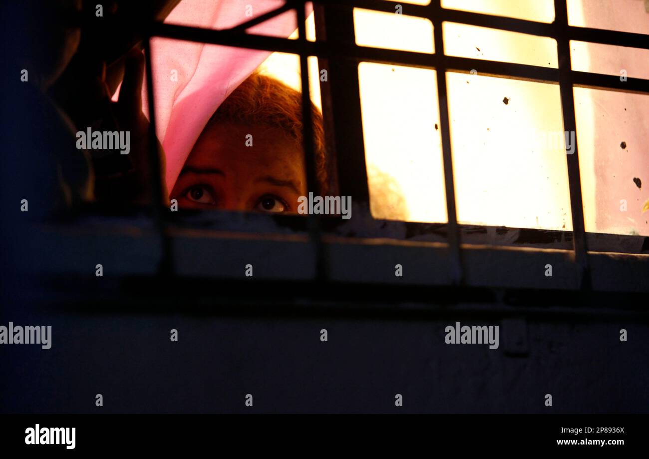 A female inmate peeks through a window during a viewing of the Mexican ...