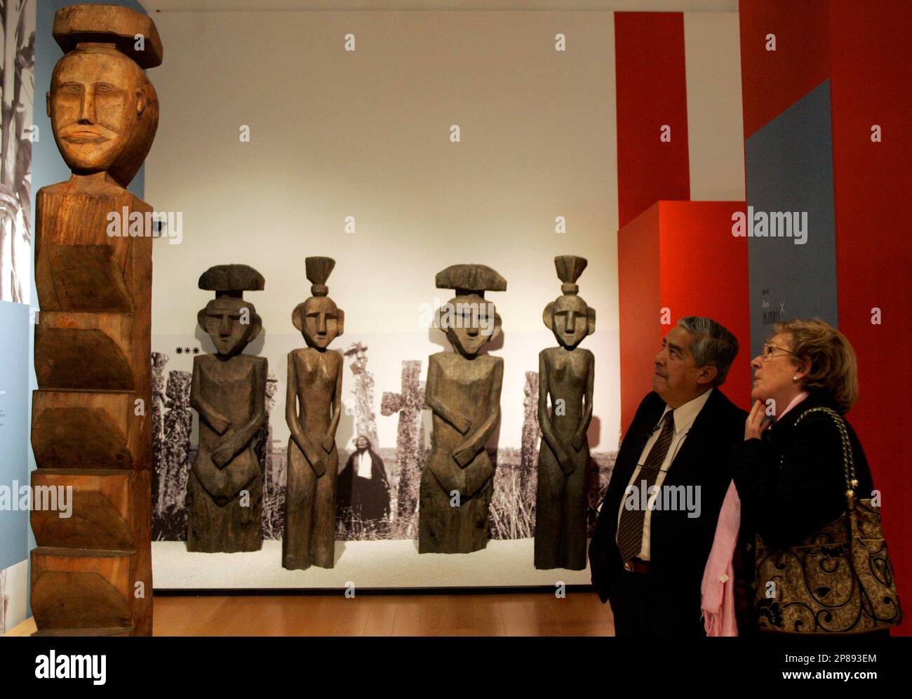 Visitors look at wood pieces from Chile's Mapuches pre-Hispanic culture ...