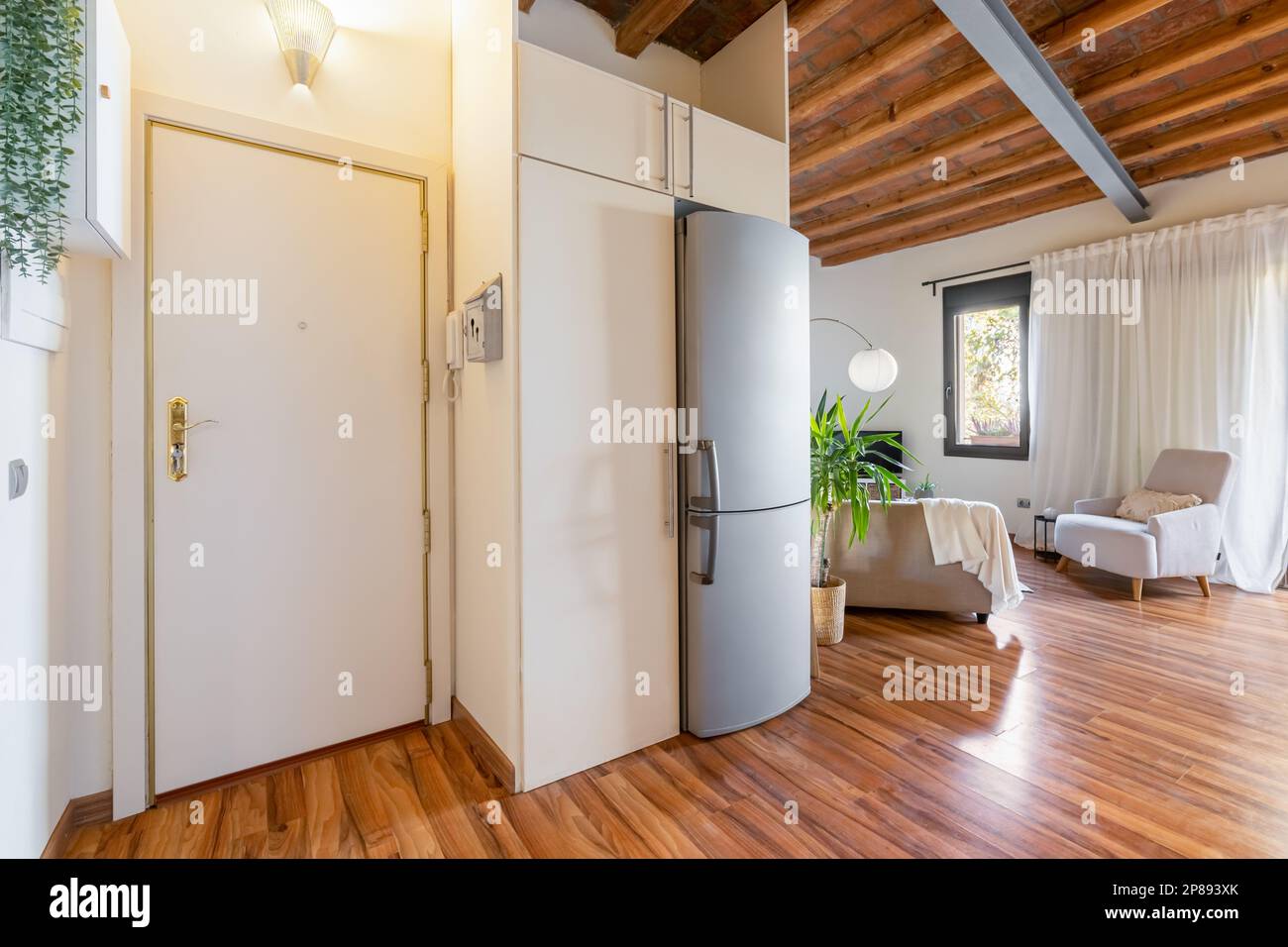 View of the front door from the inside in bright spacious living room ...