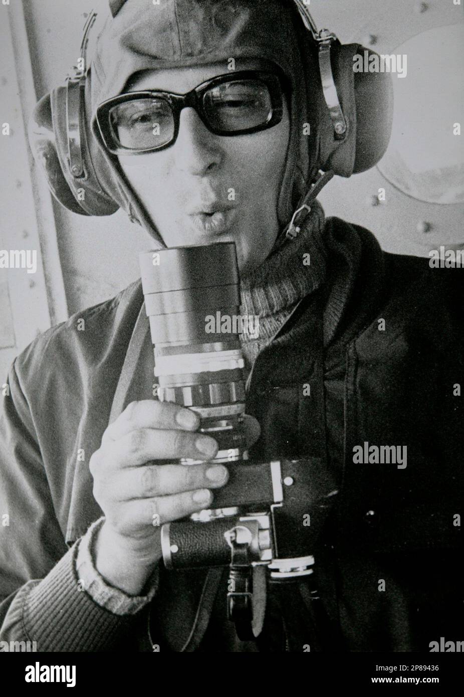 German photographer Fritz Reiss wears ear protectors as he takes ...