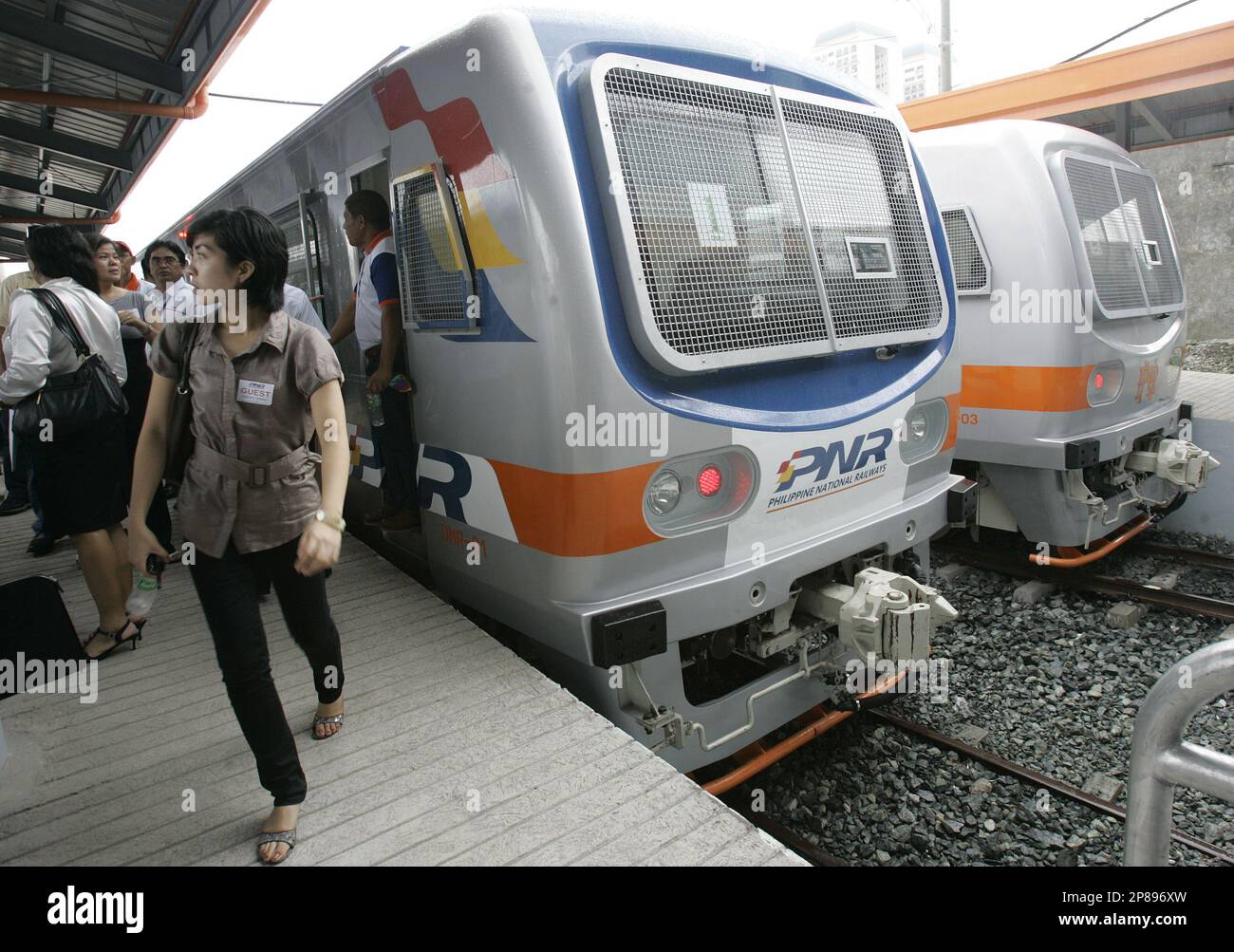 Guests alight from a new commuter train during its launch by the ...