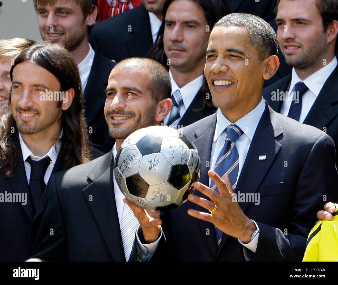 President Barack Obama tosses a soccer ball as he poses for a picture ...