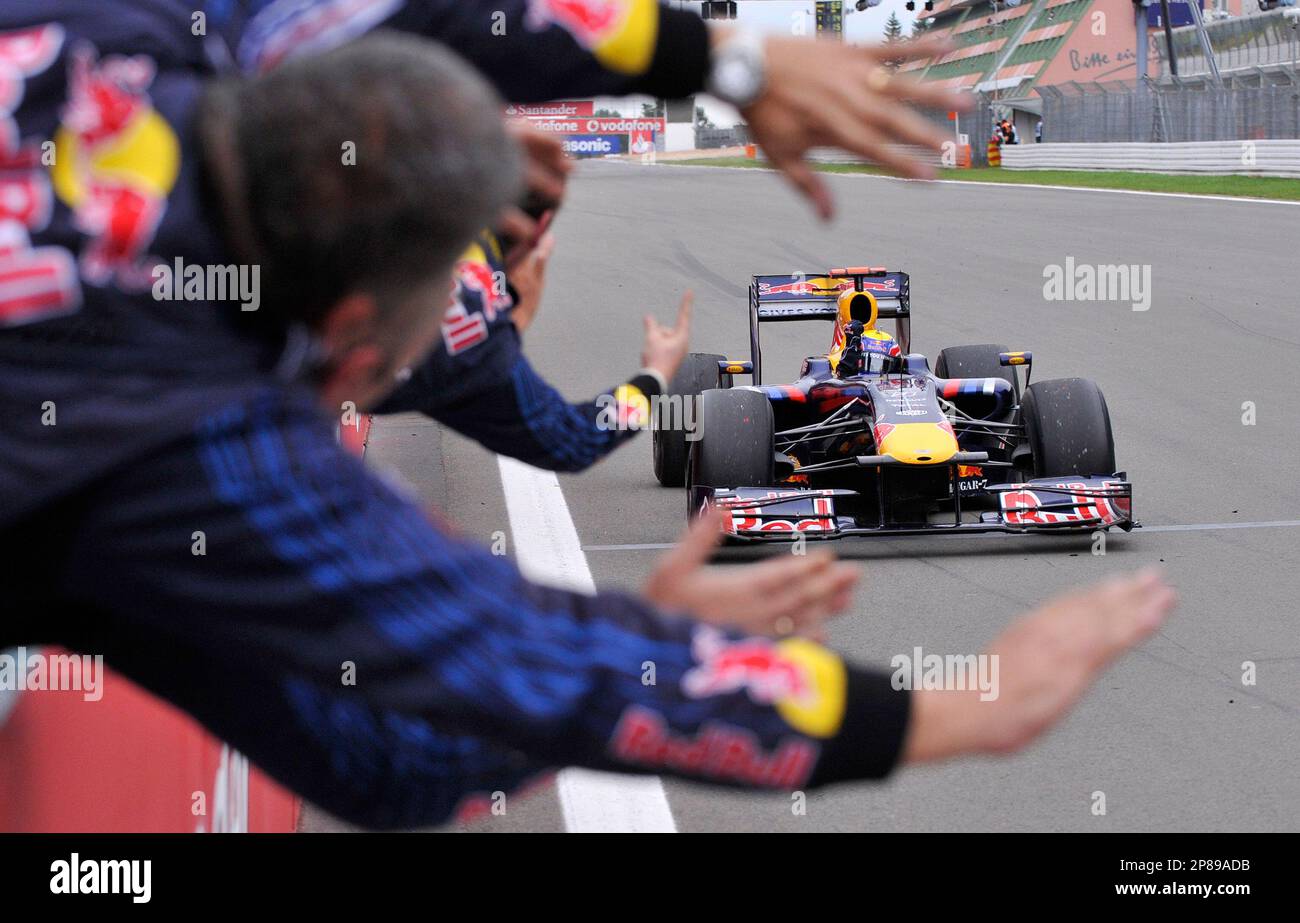 Red Bull driver Mark Webber of Australia reacts as he crosses the finish line after the German ...