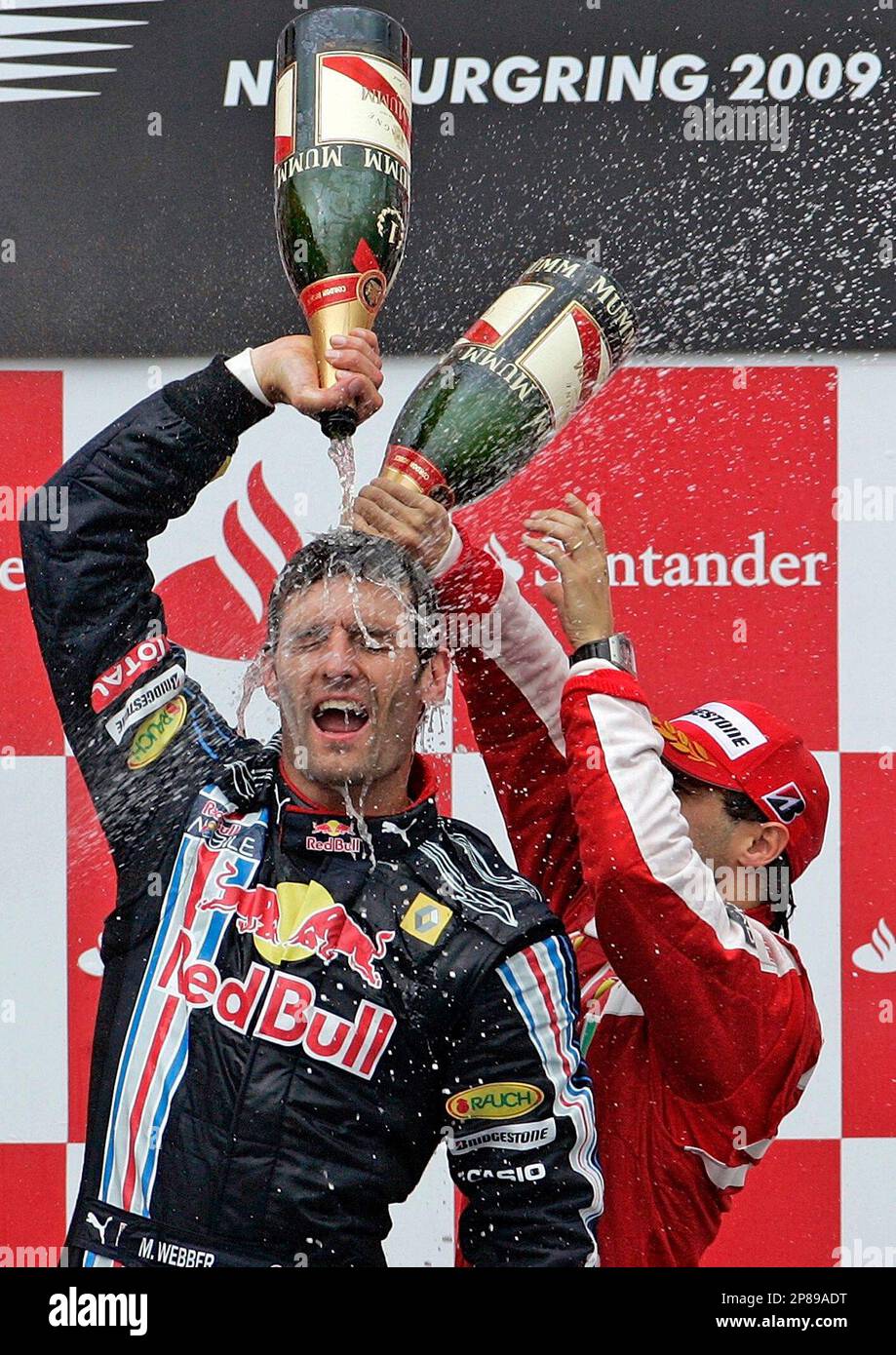 Race winner Red Bull driver Mark Webber of Australia, left, and third placed Ferrari Formula One ...