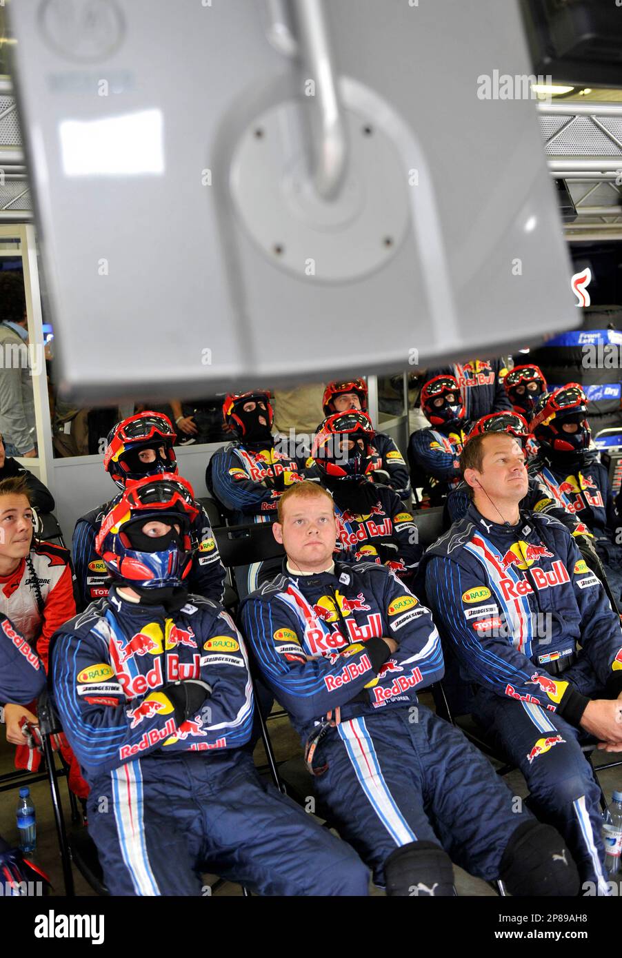 Mechanics of Red Bull F1 team watch the race on TV screens in the ...