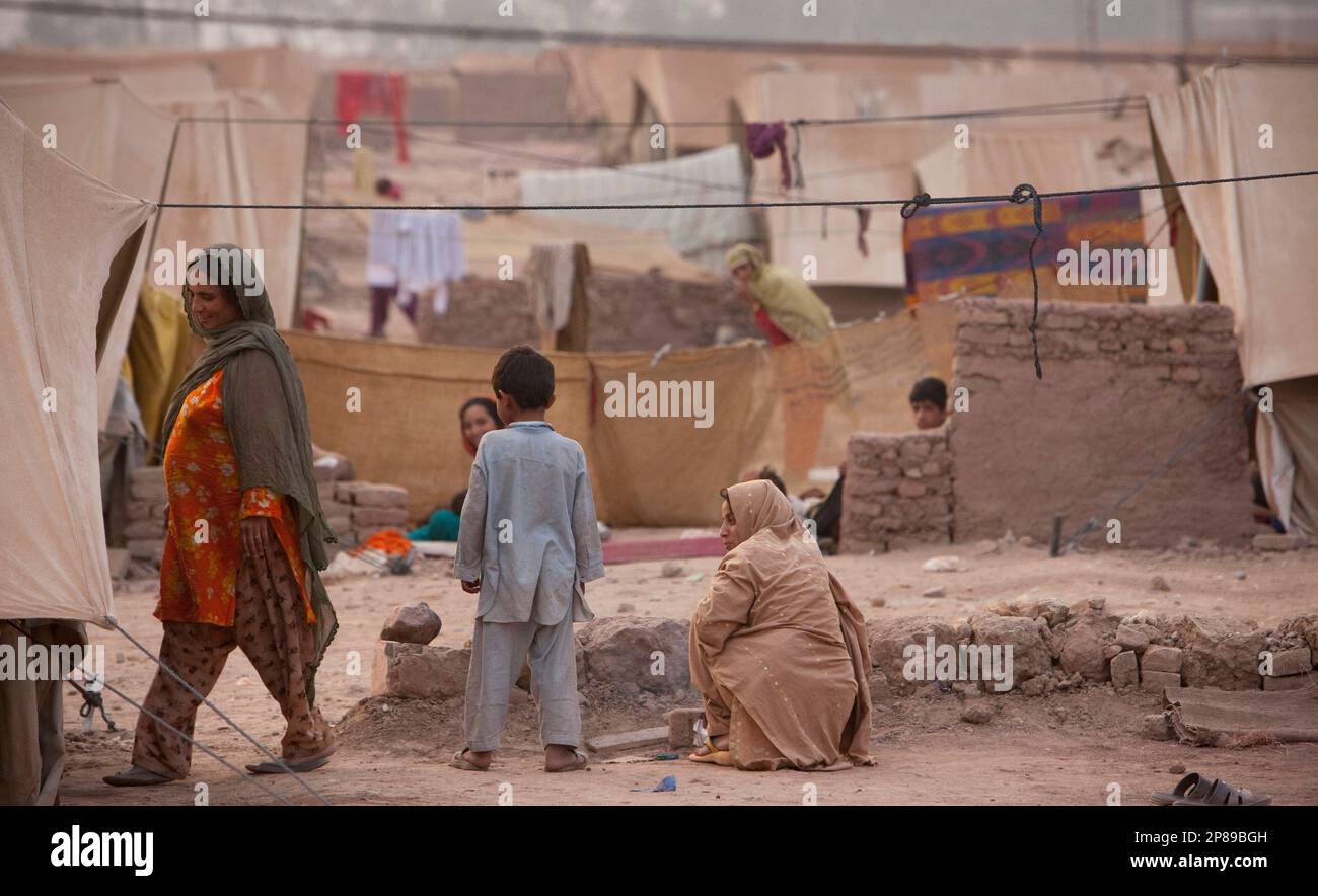Pakistani displaced family start their day outside their family tent ...