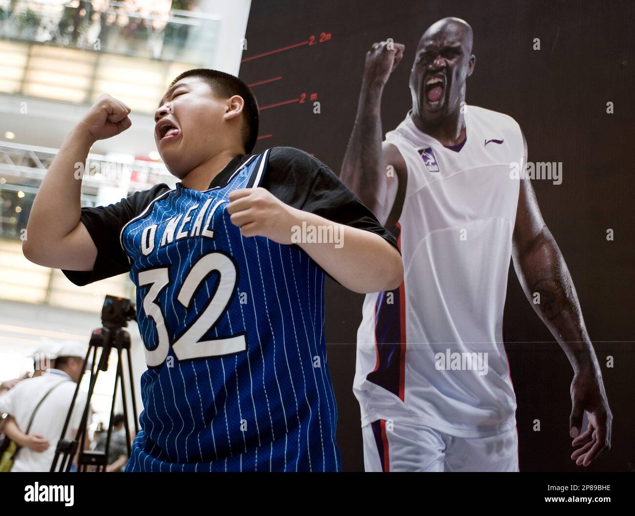A young Chinese fan mimics a poster of NBA Cleveland Cavaliers center ...