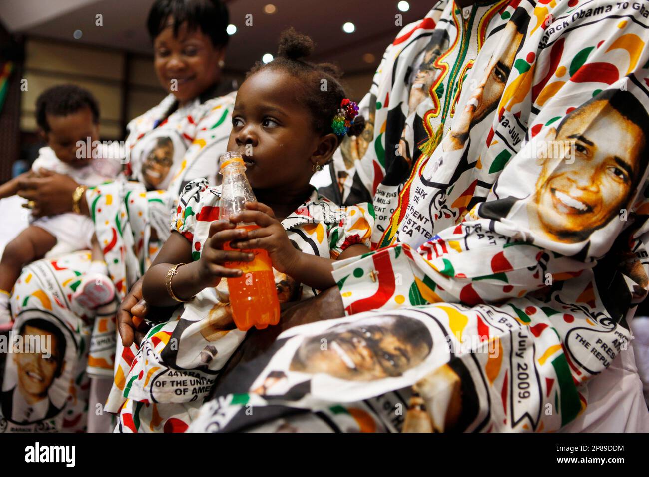 Princess Smith, 2, sits with her family, wearing traditional dress ...