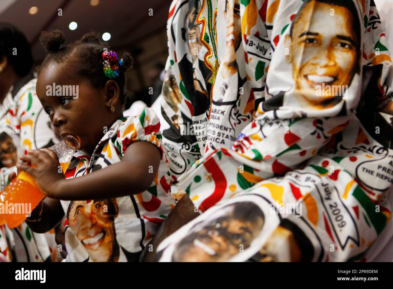Princess Smith, 2, sits with her family, wearing traditional dress ...