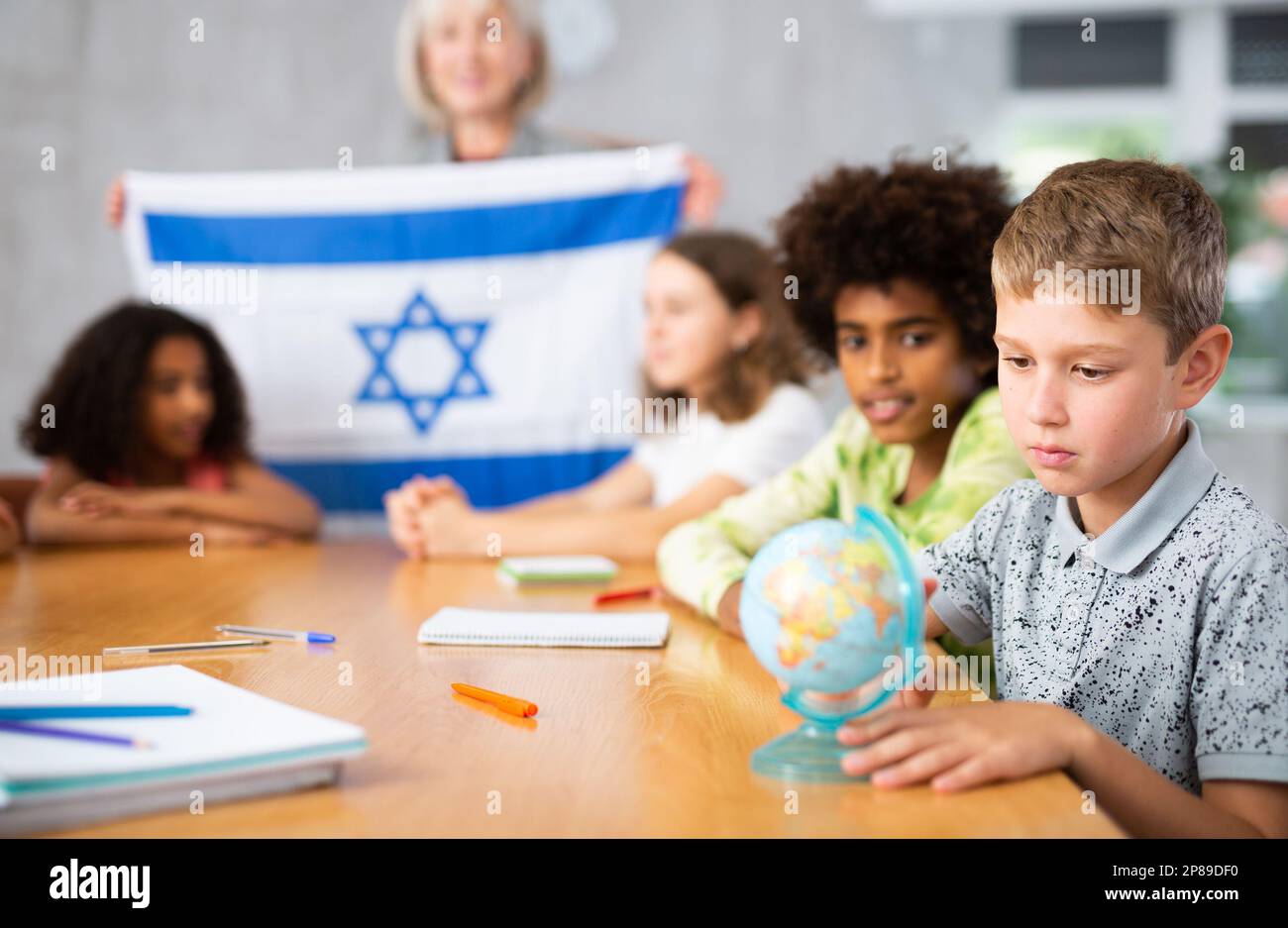Female teacher showing israeli flag to kids in geography class Stock ...