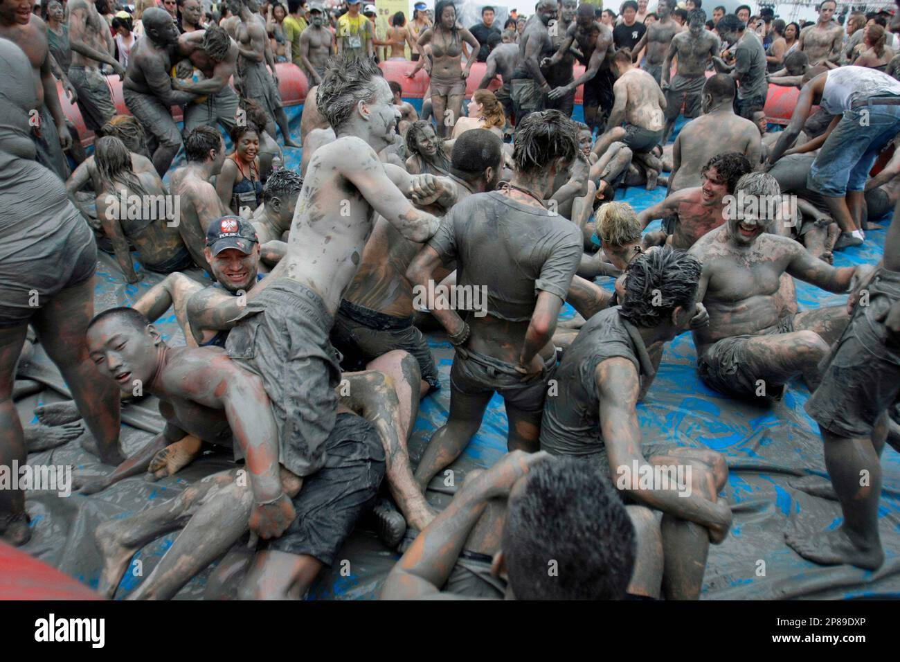 Tourists play with mud during the Boryeong Mud Festival on Daecheon ...
