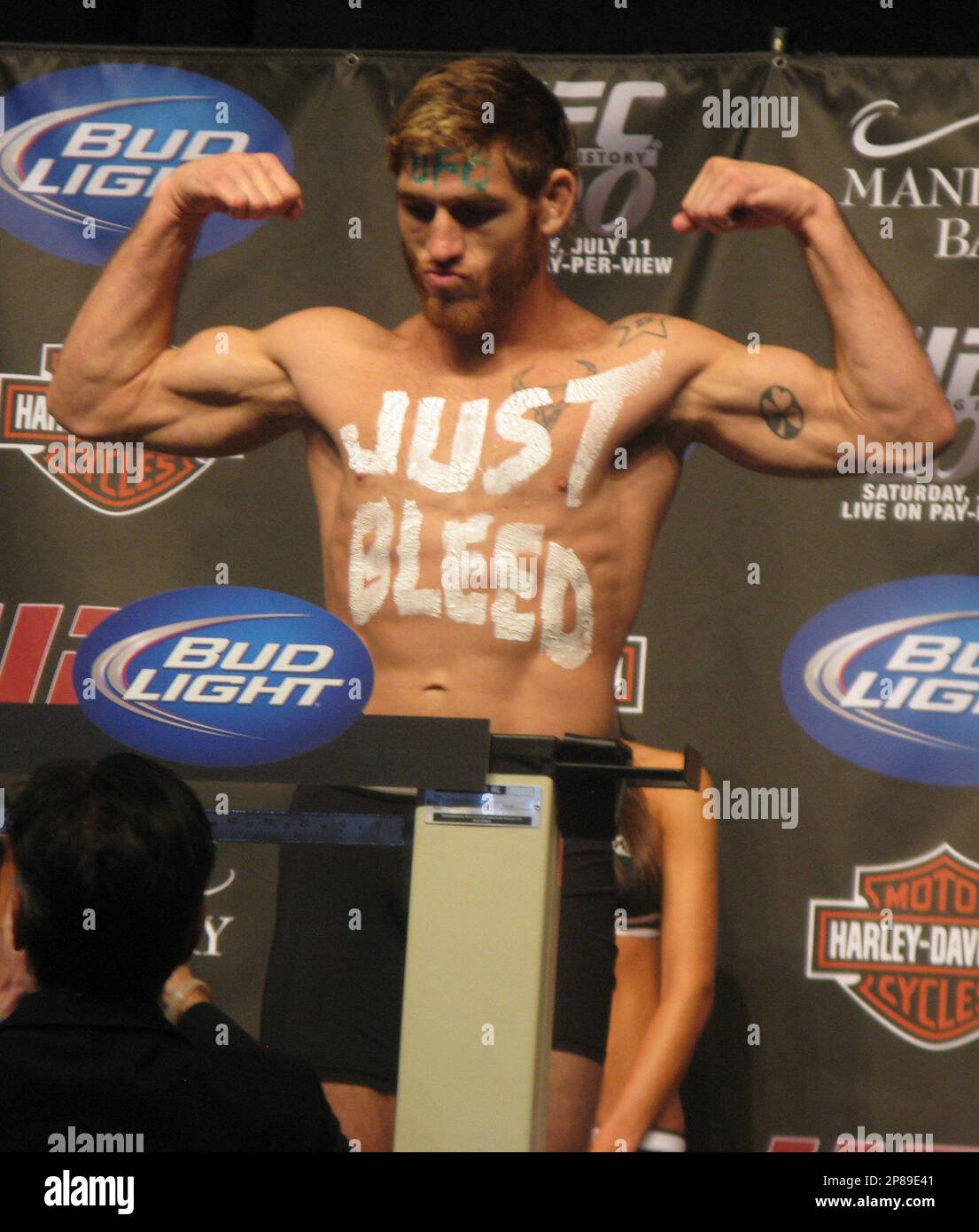 Mixed martial arts fighter Tom Lawlor, of Orlando, Florida, flexes his ...