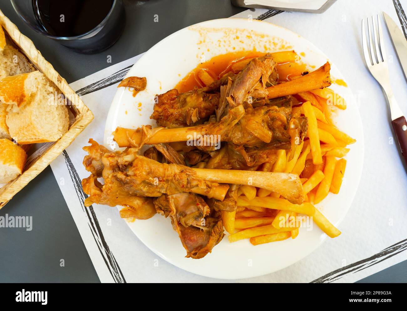 Baked lamb shins from oven with sauce Stock Photo - Alamy