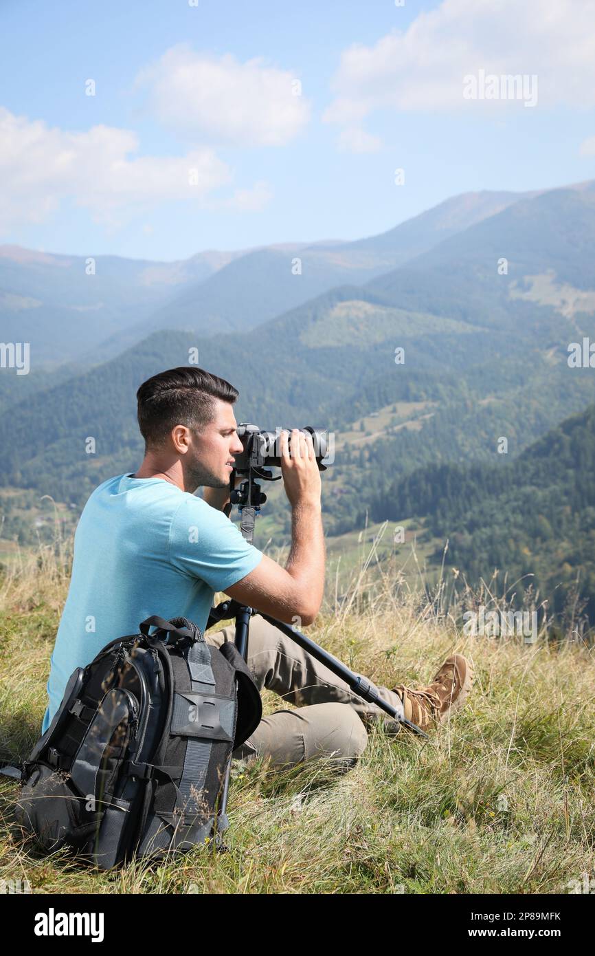 Professional photographer taking picture with modern camera in ...