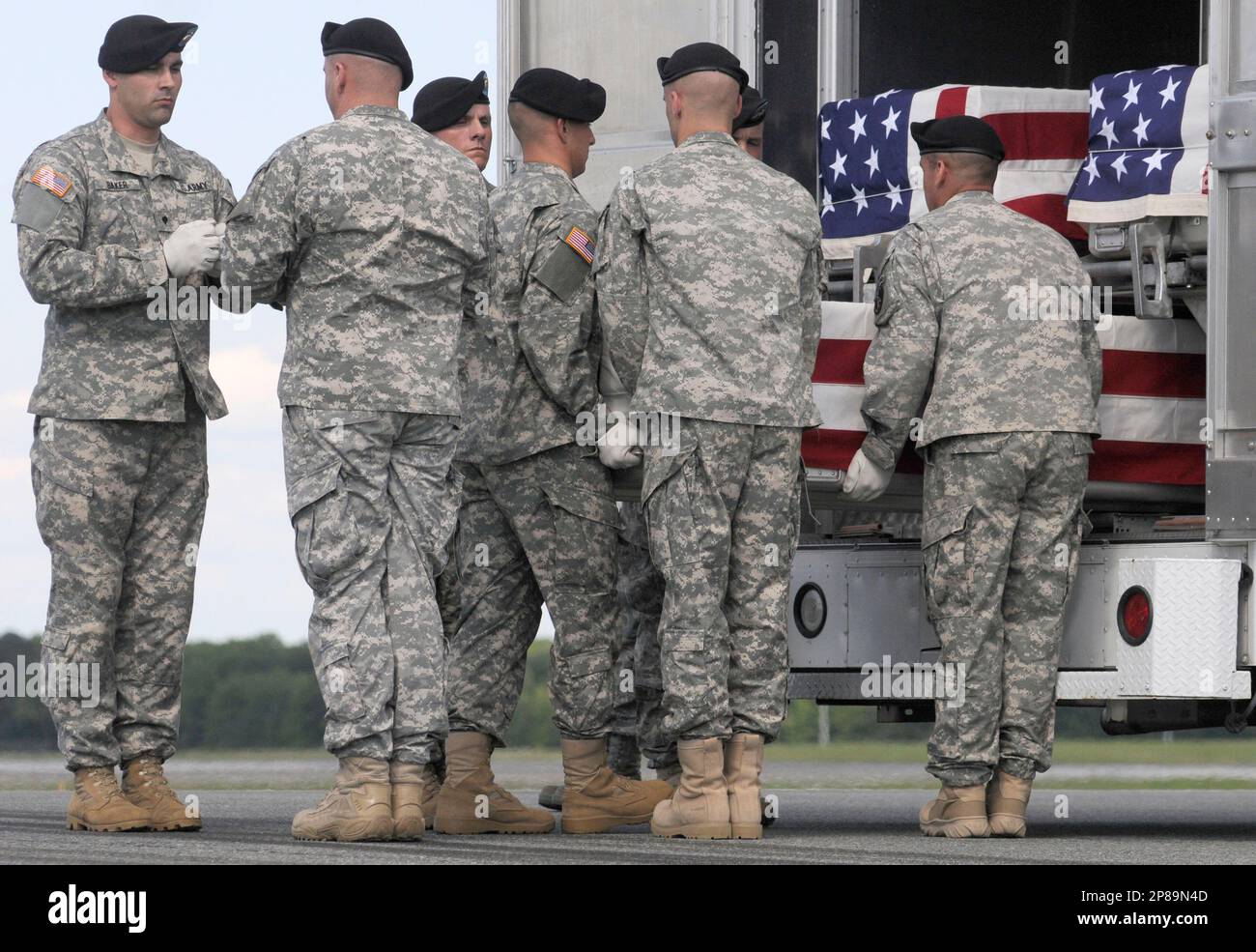 An Army carry team carries a transfer case containing the remains of ...