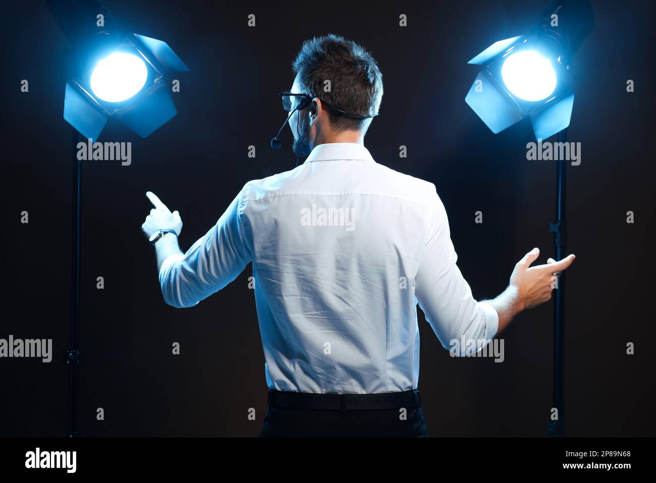 Motivational speaker with headset performing on stage, back view Stock ...