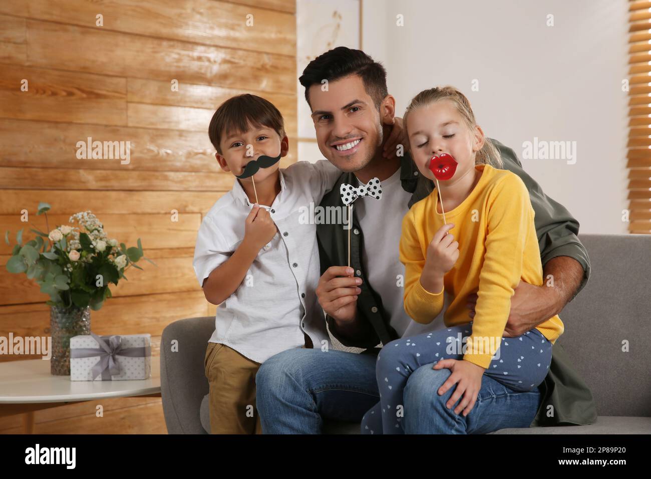 Dad and his children having fun at home. Happy Father's Day Stock Photo ...