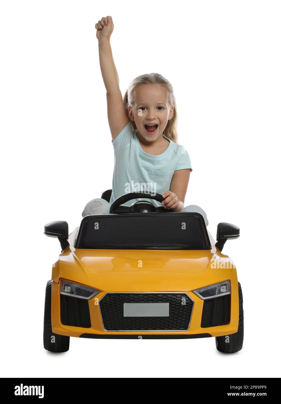Cute little girl driving children's electric toy car on white ...
