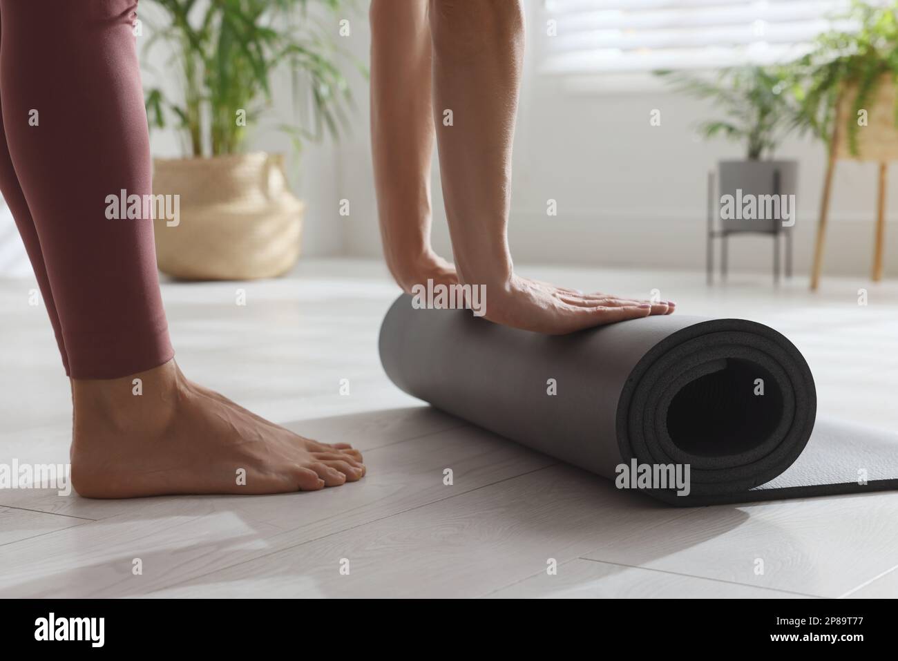 Woman unrolling exercise mat hi-res stock photography and images - Alamy