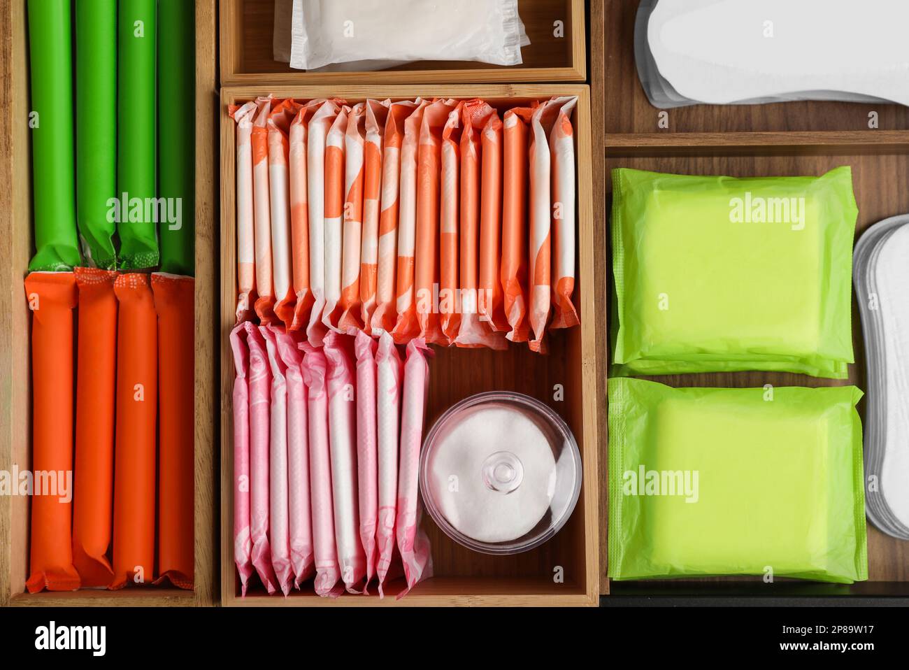Storage of different feminine hygiene products in wooden organizers ...