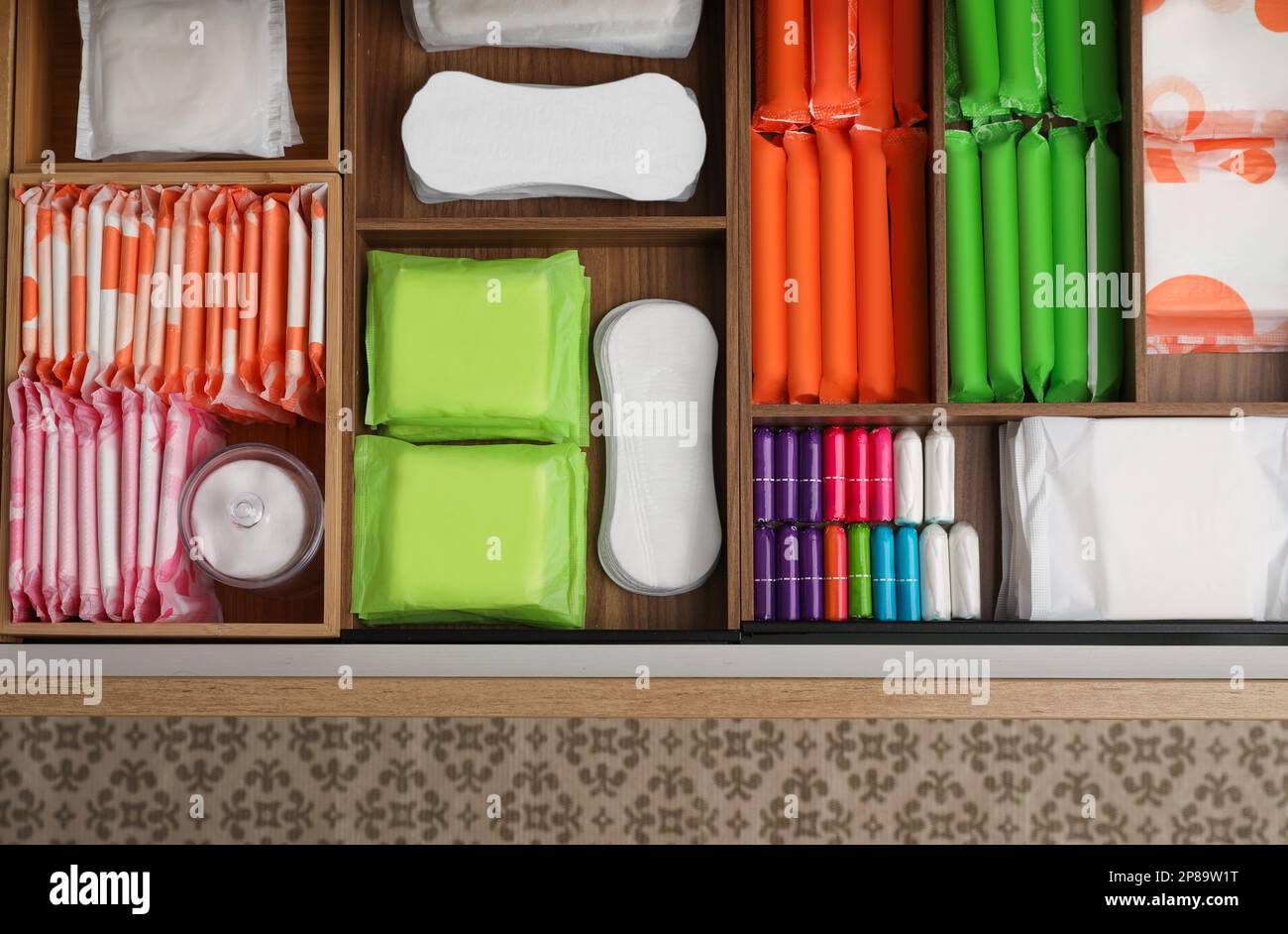 Storage of different feminine hygiene products in wooden drawer, top ...