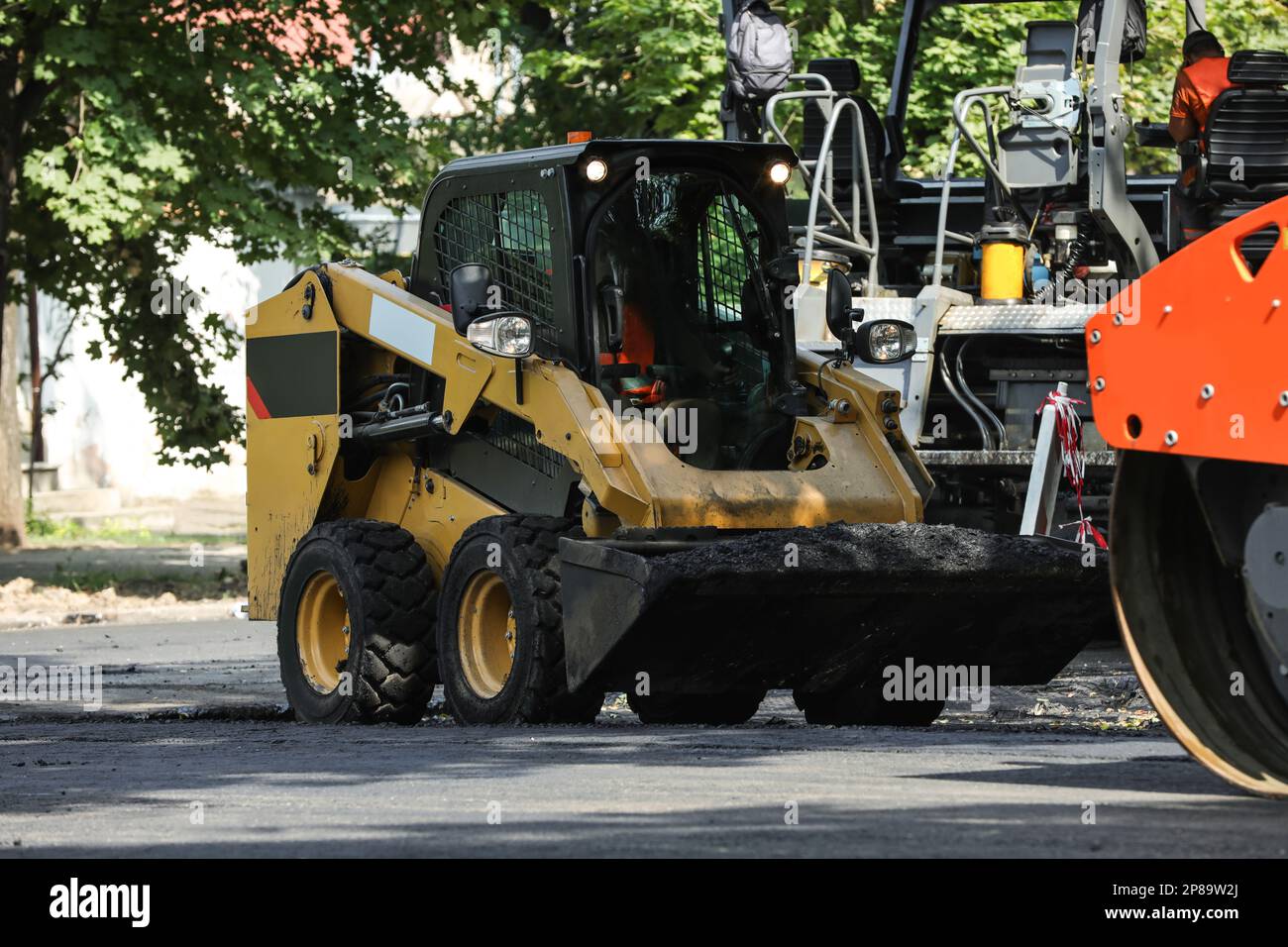 Skid loader on road hi-res stock photography and images - Alamy