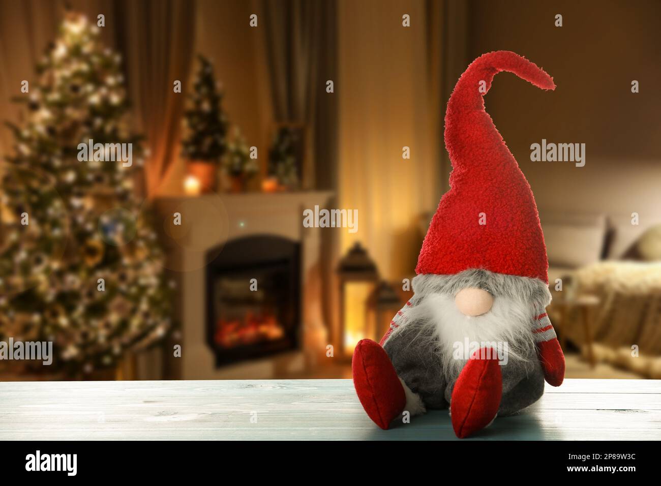 Funny Christmas gnome on turquoise wooden table in room with festive ...