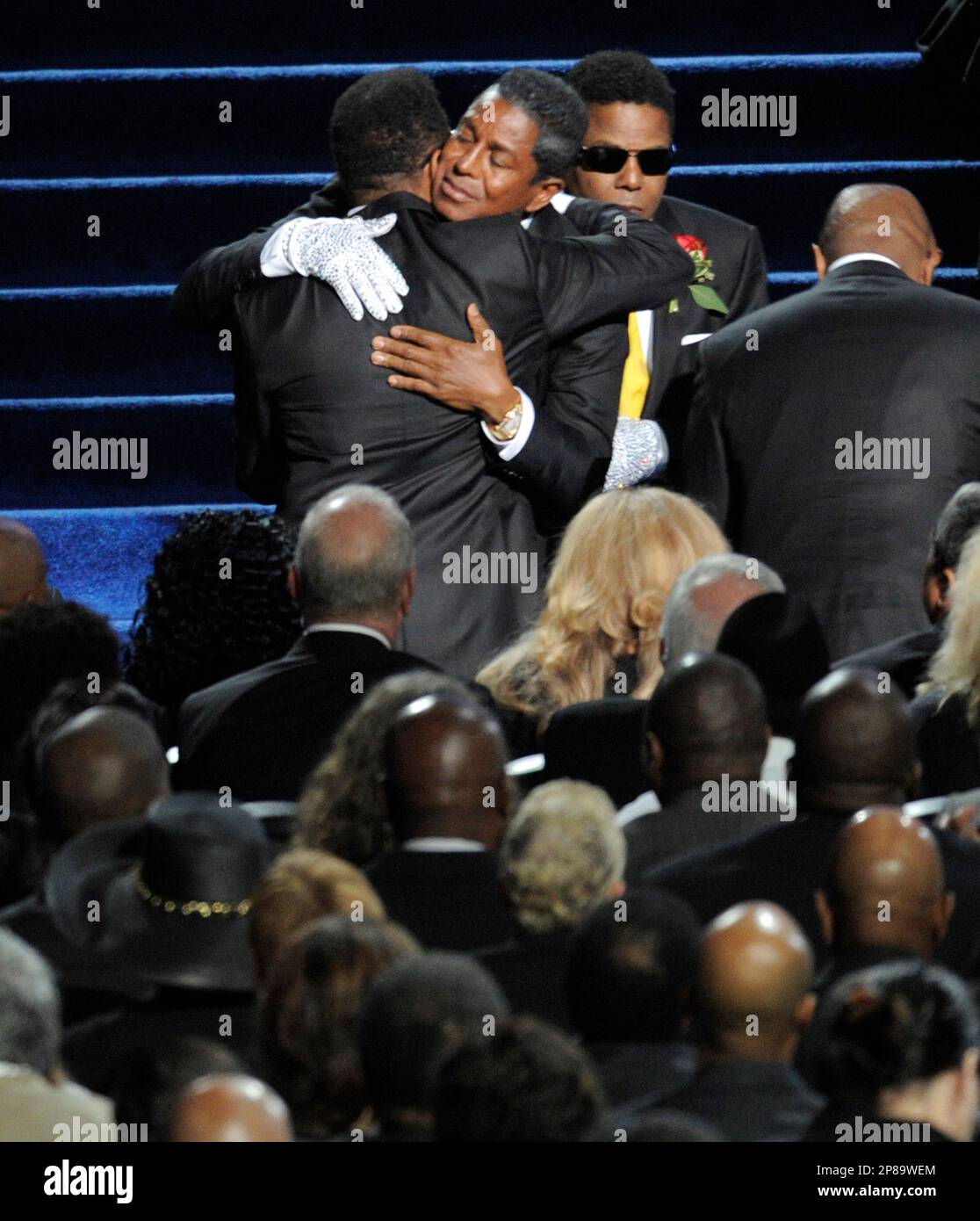 Jermaine Jackson, center, hugs family members after singing at the ...