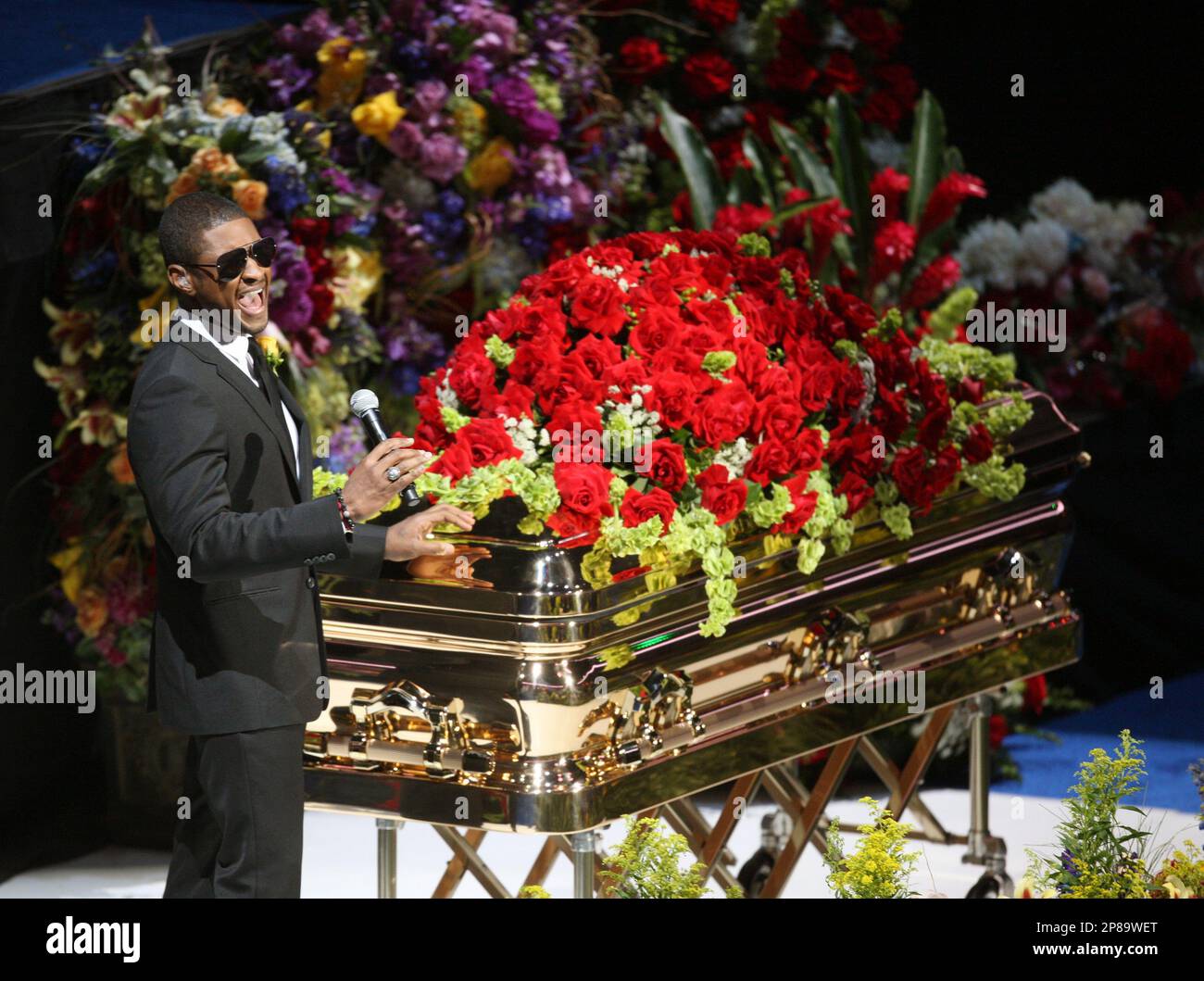 Usher performs at the casket during the memorial service for the late ...