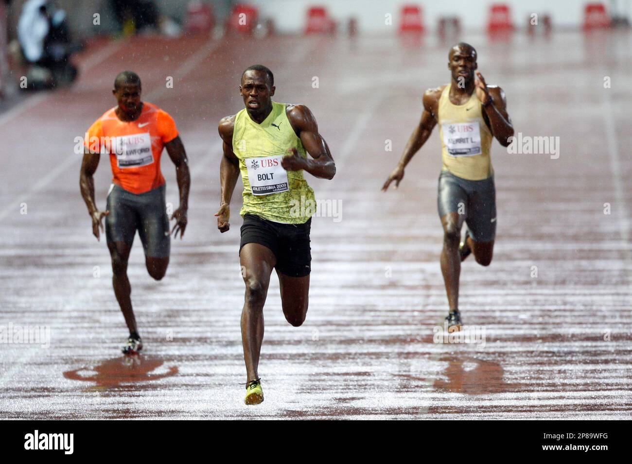 Usain Bolt of Jamaica, center, runs the men's 200 m race ahead of Shawn ...