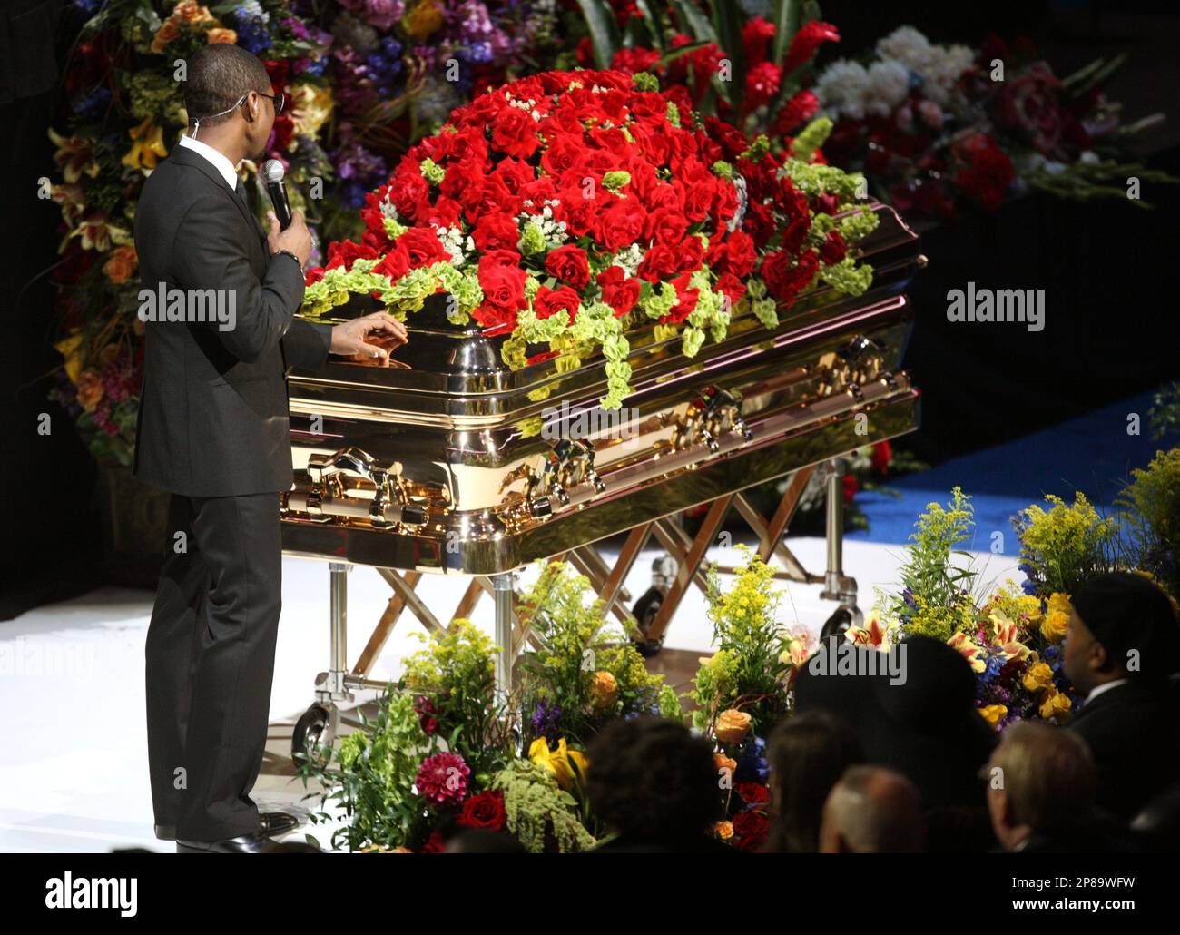 Usher performs at the casket during the memorial service for the late ...