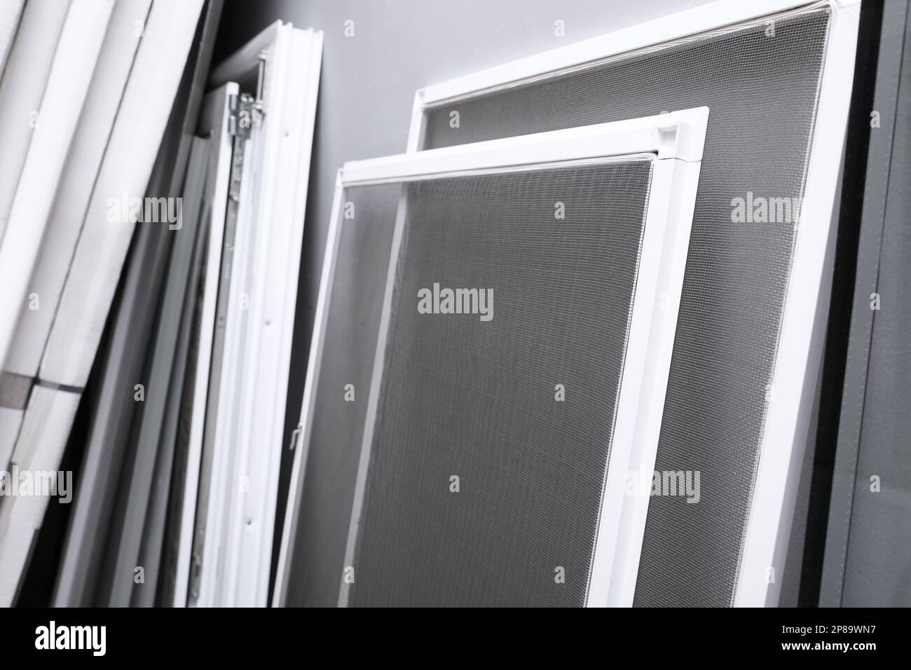 Mosquito window screens near grey wall, closeup Stock Photo - Alamy
