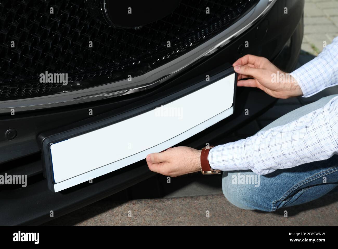 Man installing vehicle registration plate outdoors, closeup Stock Photo ...