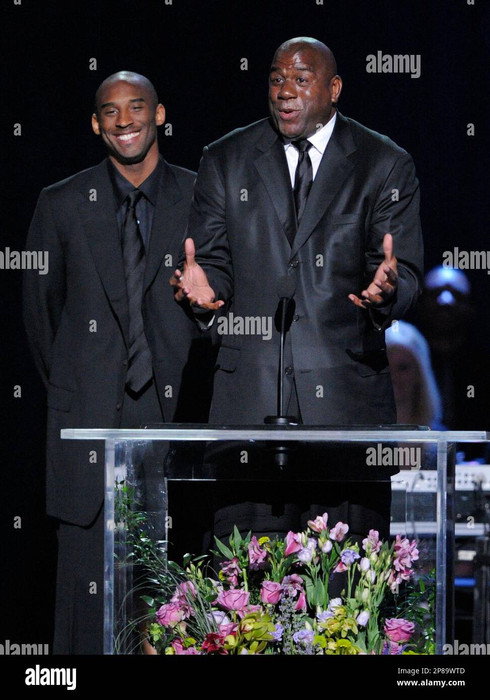 LA Lakers' Kobe Bryant, left, and Magic Johnson speak during the ...