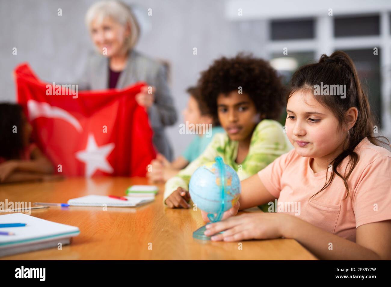 Female teacher showing turkish flag to kids in geography class Stock ...