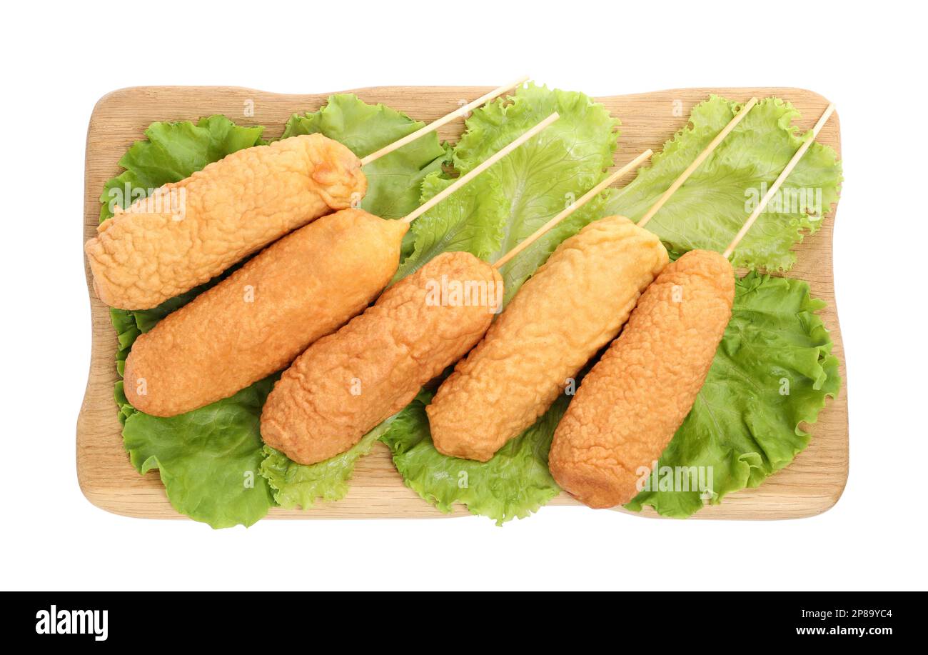 Delicious deep fried corn dogs with lettuce on white background, top ...
