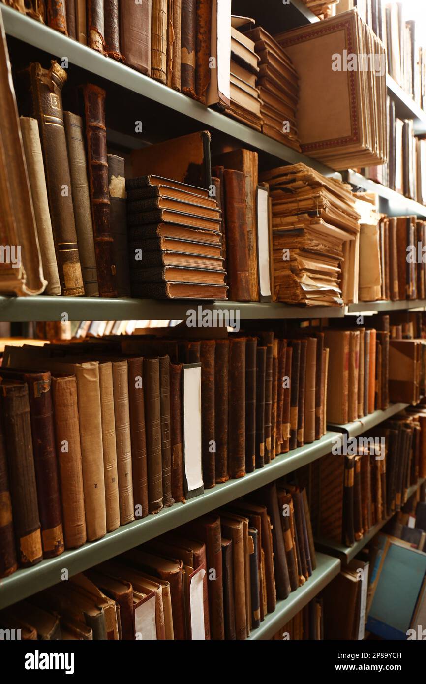 Collection of old books on shelves in library Stock Photo - Alamy